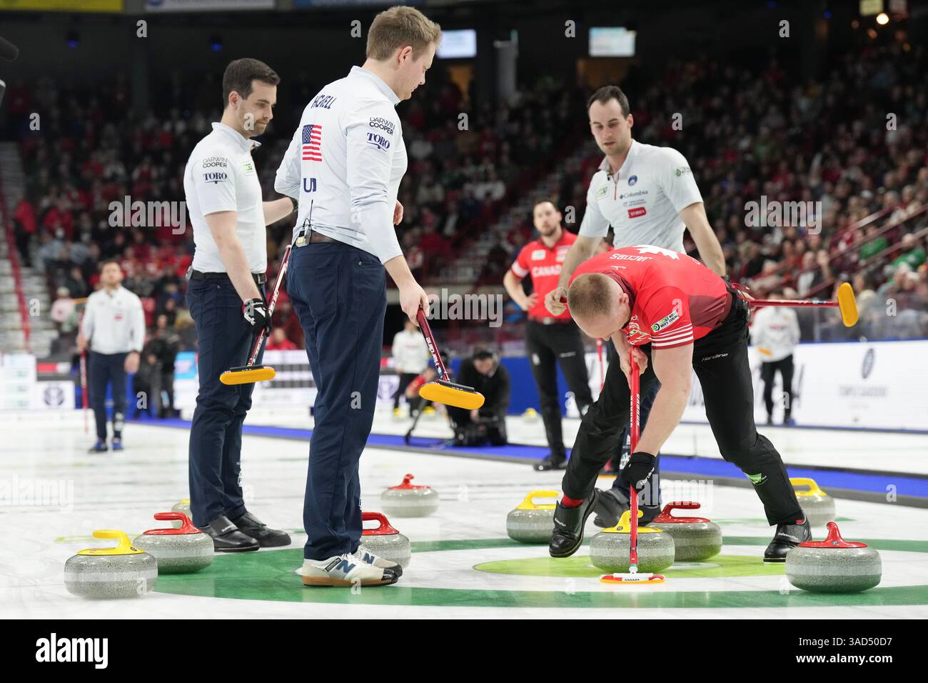 Canada's skip Brad Jacobs sweeps a stone from USA skip Korey Dropkin ...