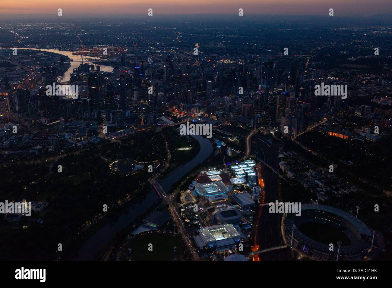 Aerial view of the Olympic Park Precinct lit up at dusk against the ...