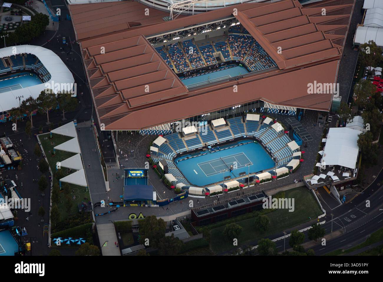 Margaret Court Arena lit up at dusk, photographed from the air during ...