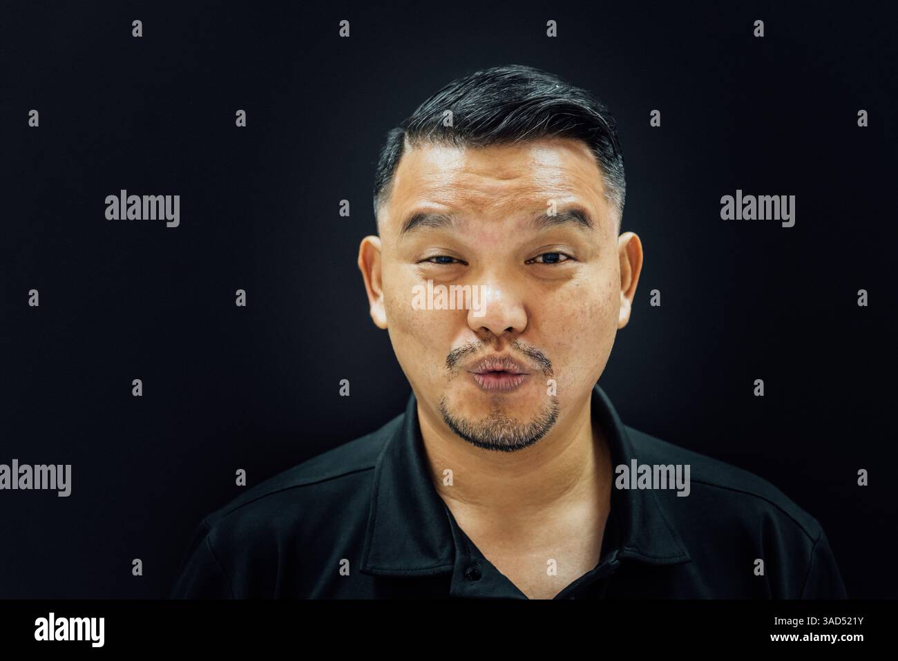 Asian man 40s have a short hair with a beard in black polo shirt mouth ...
