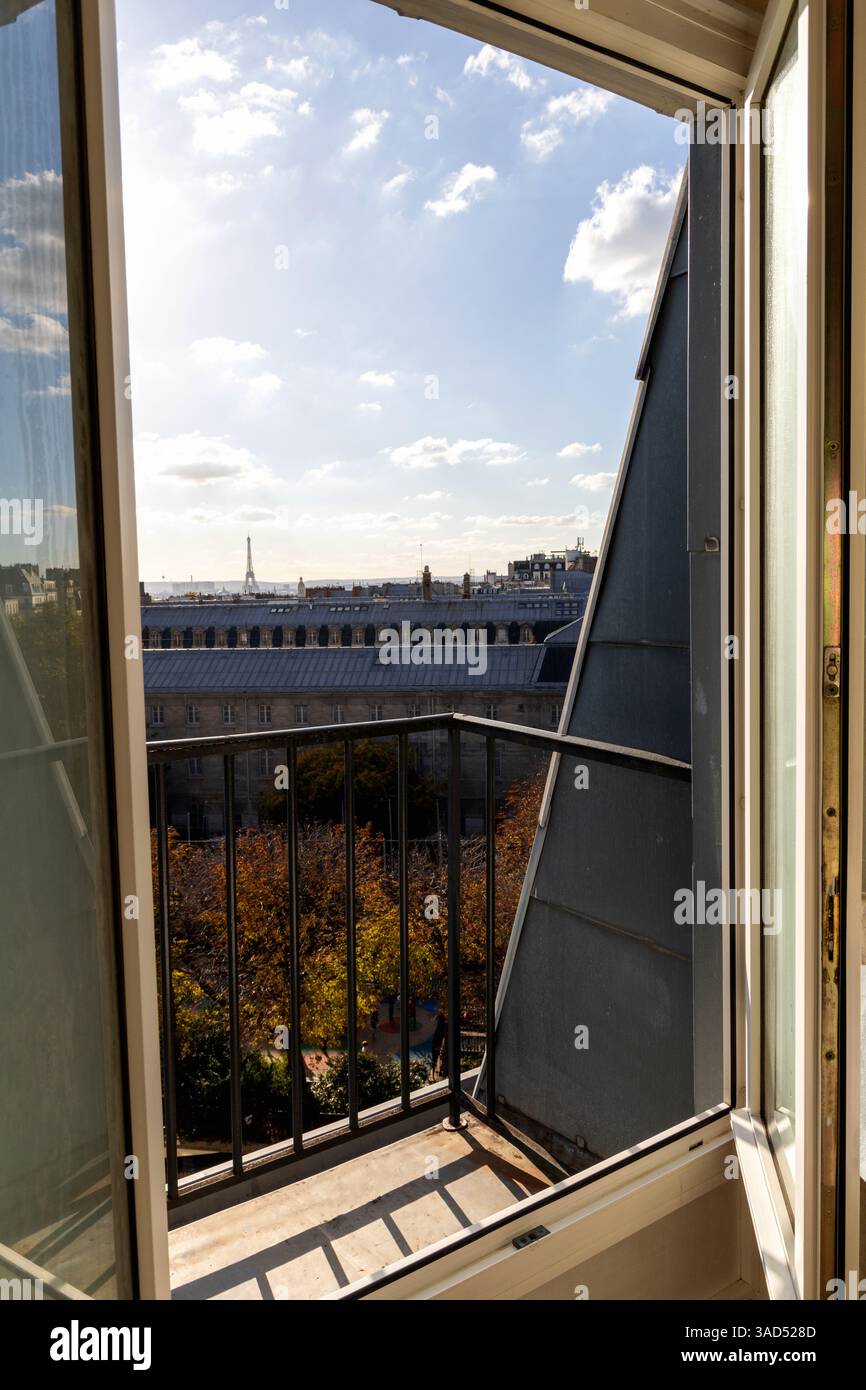 Open window with romantic view of rooftops and Eiffel Tower in Paris ...