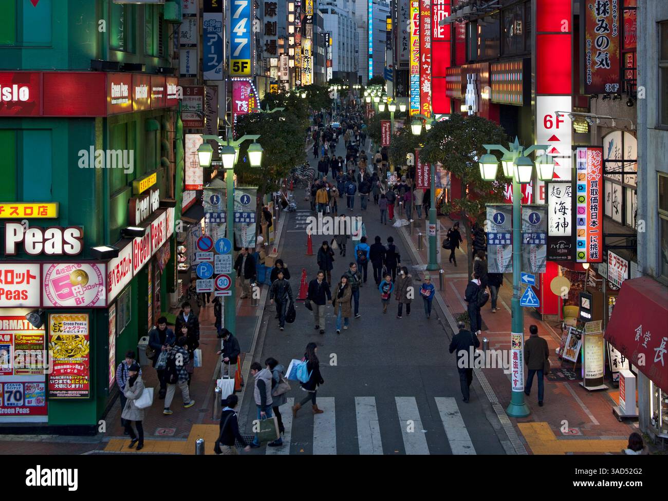 Neon signs light up the building facades along Musashino Street in the ...