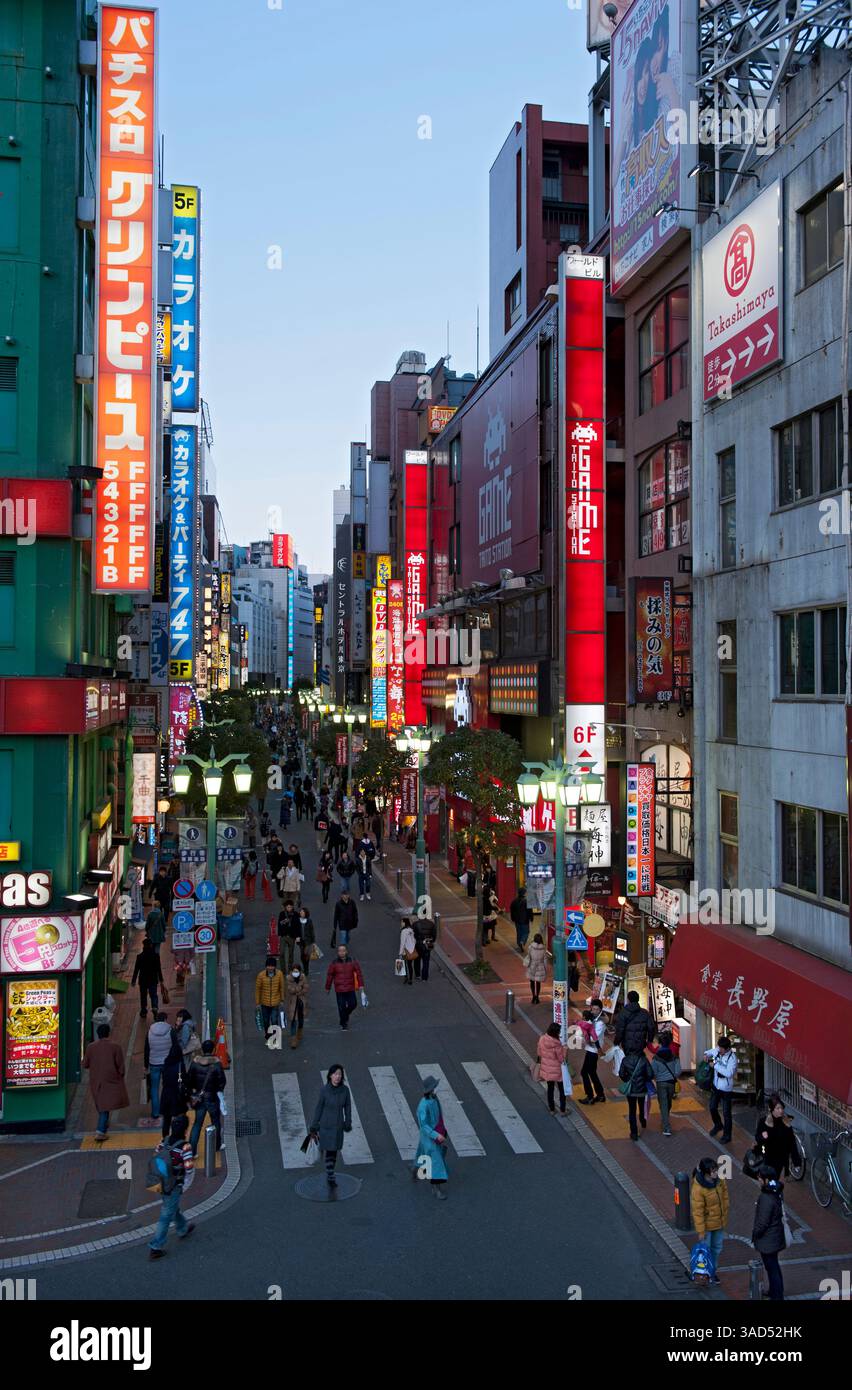 Neon signs light up the building facades along Musashino Street in the ...