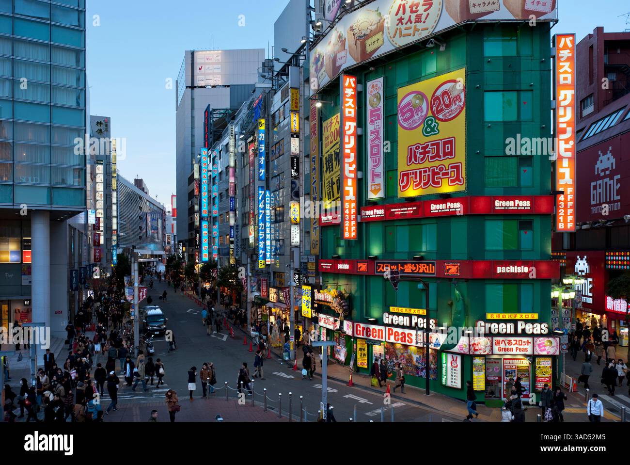 Neon signs light up the building facades along Musashino Street in the ...