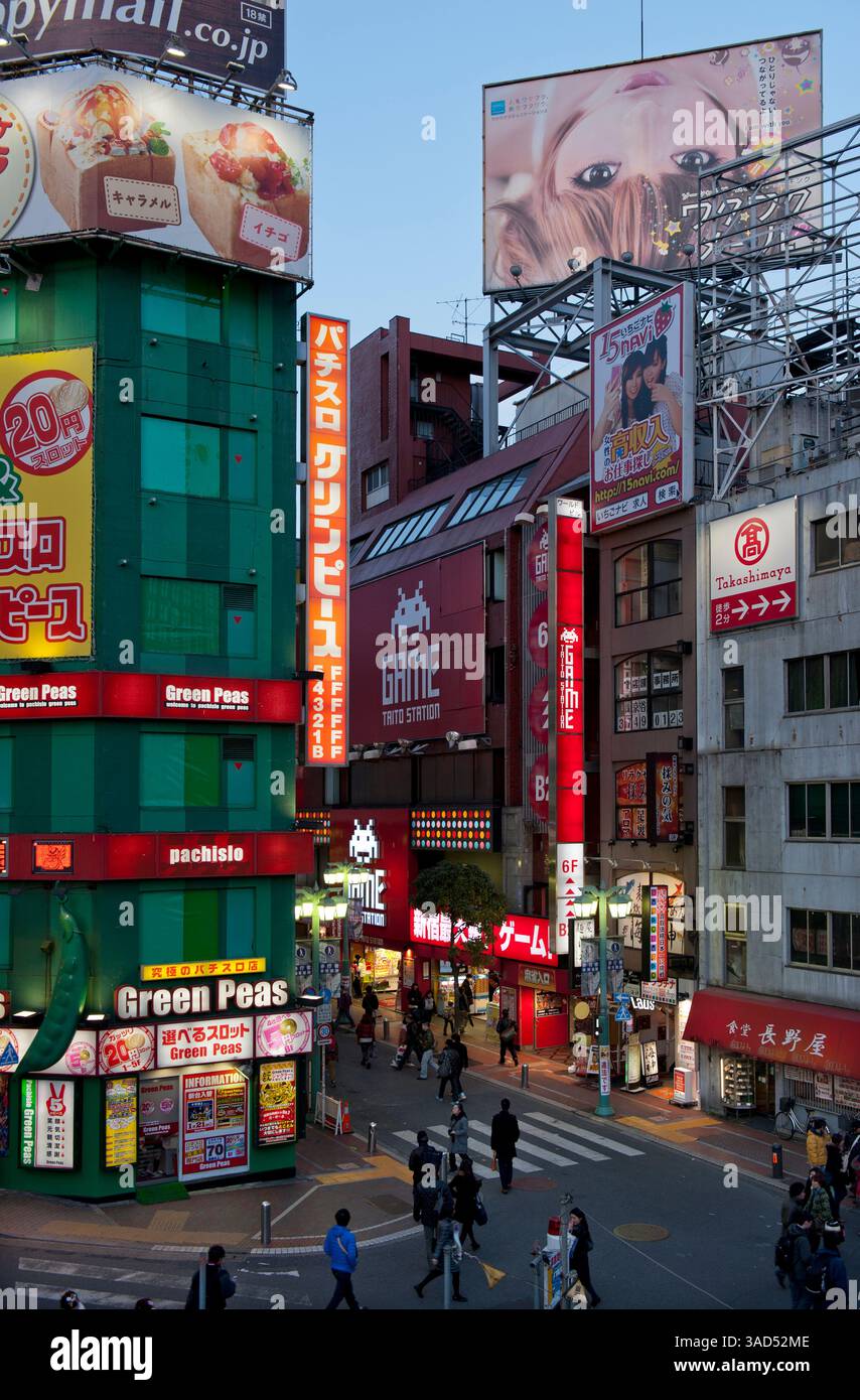 Neon signs light up the building facades along Musashino Street in the ...
