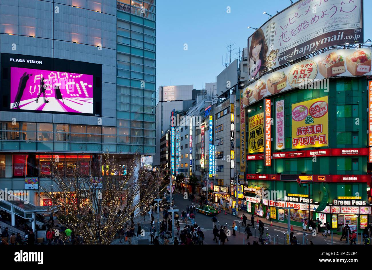 Neon signs light up the building facades in the Minami Shinjuku ...