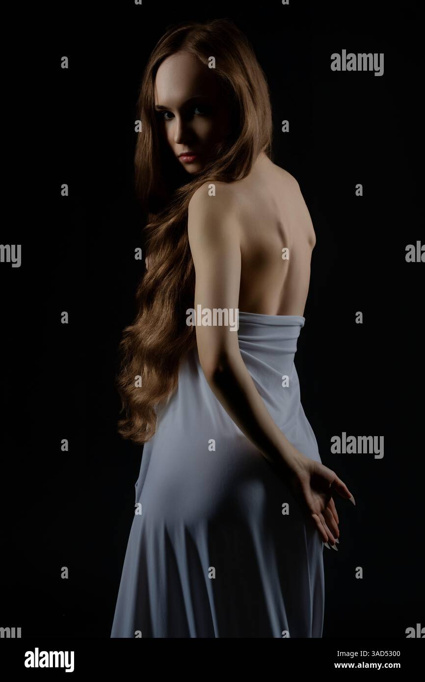 Model poses elegantly in a casting session with a dramatic backdrop ...