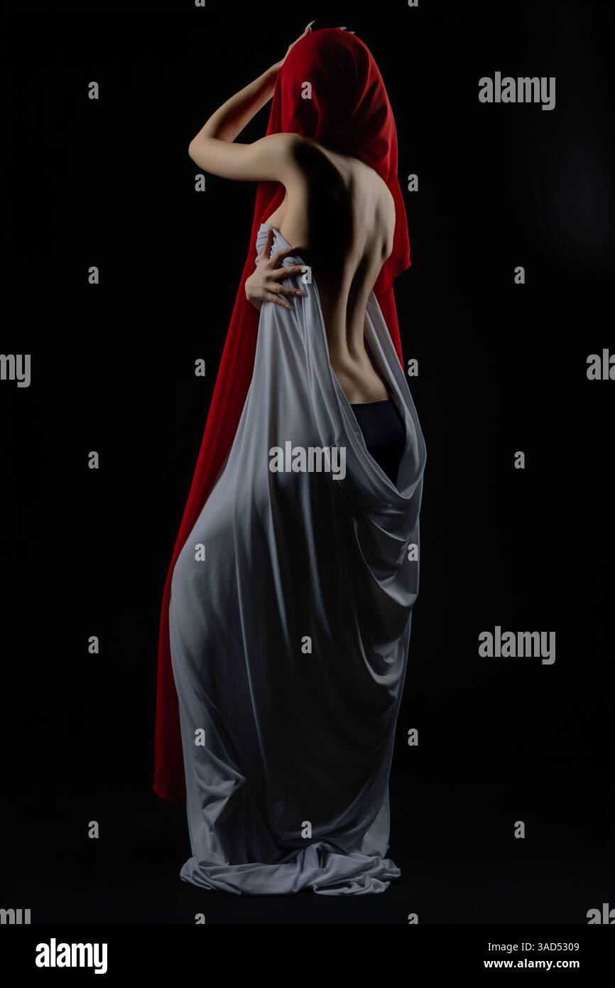 Model poses in artistic fabric draping during casting session Stock ...