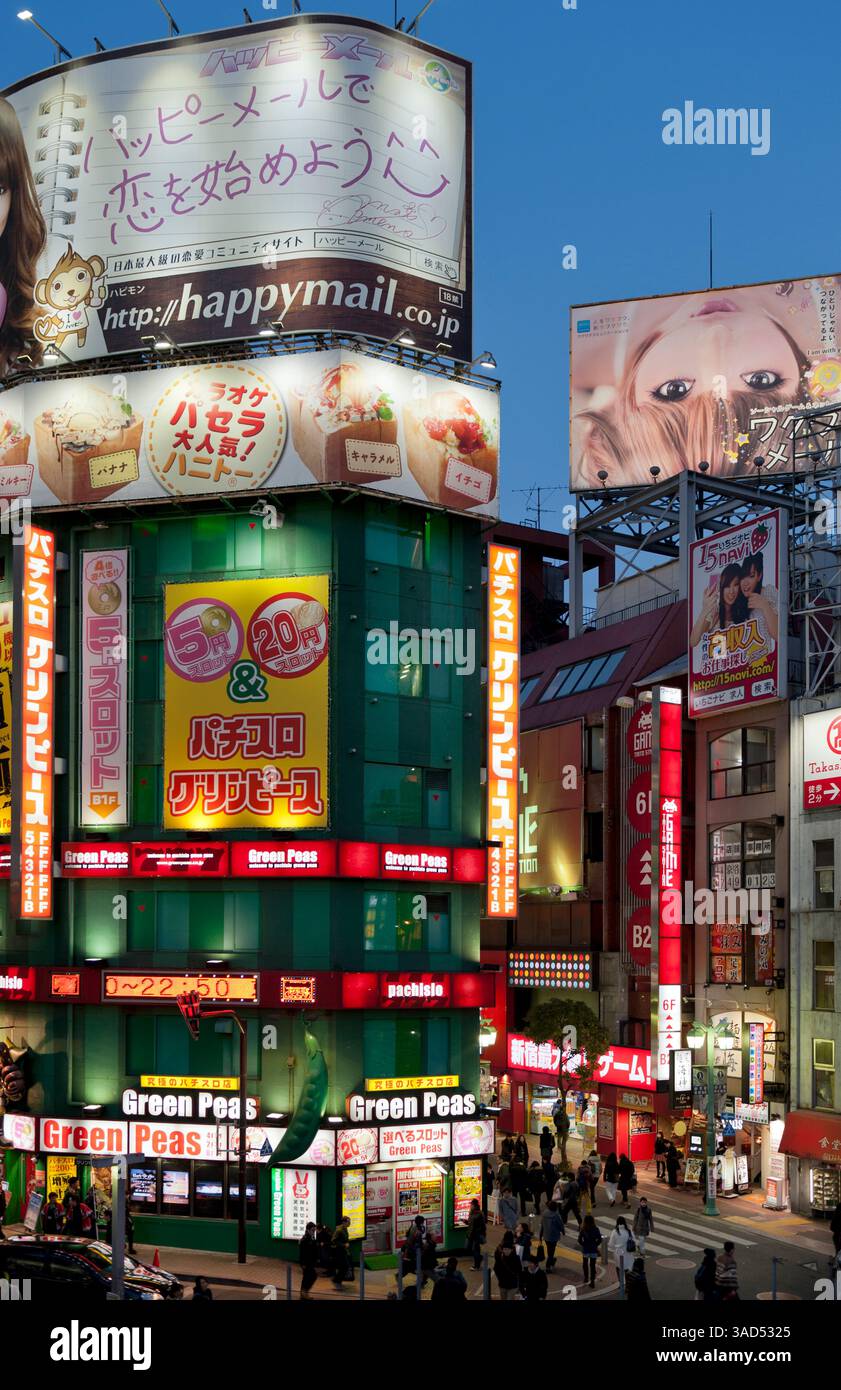 Neon signs light up the building facades in the Minami Shinjuku ...