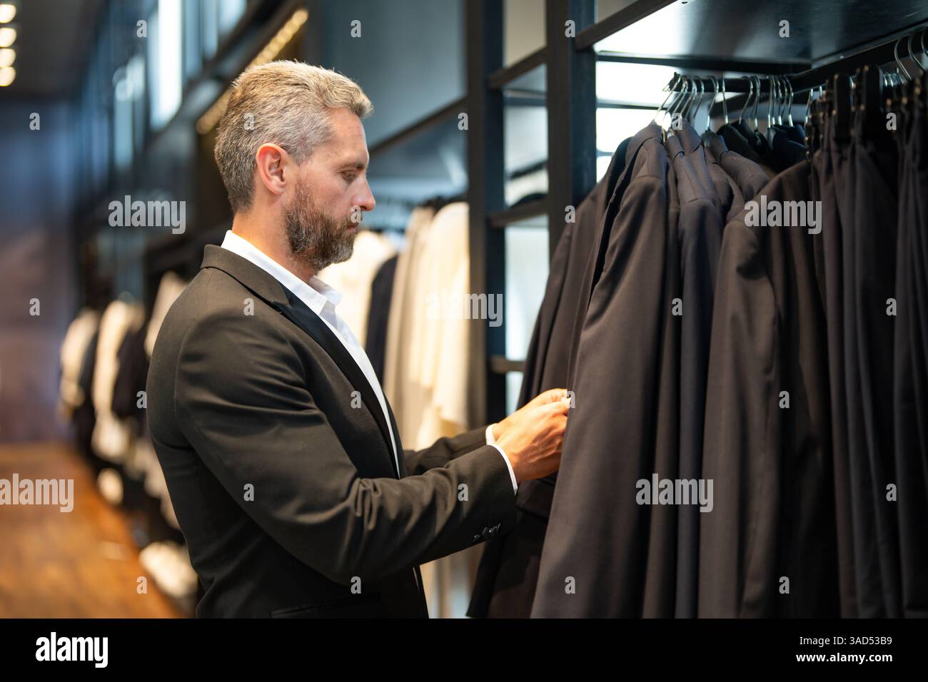 Suit for business man. A well-dressed male model poses in a suit ...