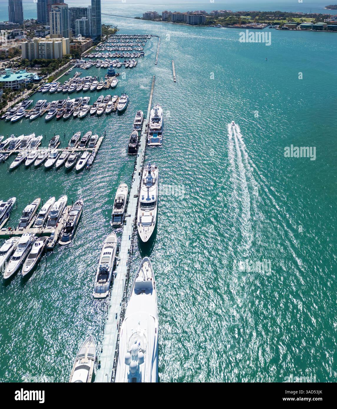 Luxury yacht cruising on Miamis coastline. Aerial view of yachts docked ...