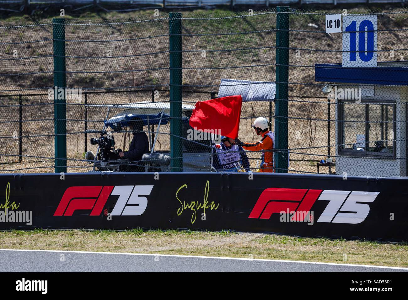 Red flag waved by a marshall during the Formula 1 Lenovo Japanese Grand ...