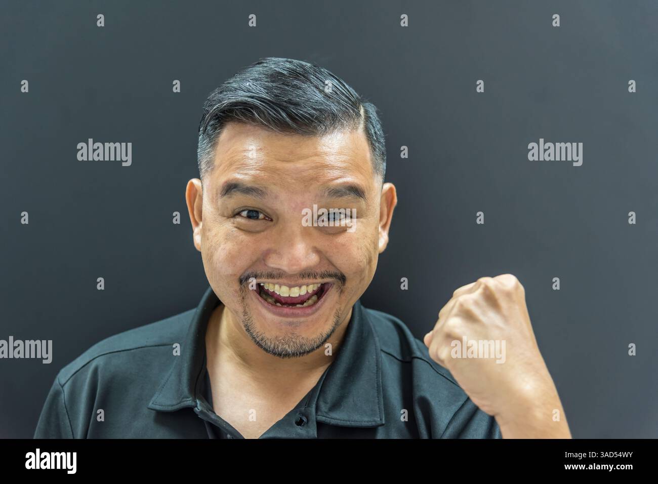 Asian man 40s have a short hair with a beard in black polo shirt have a ...