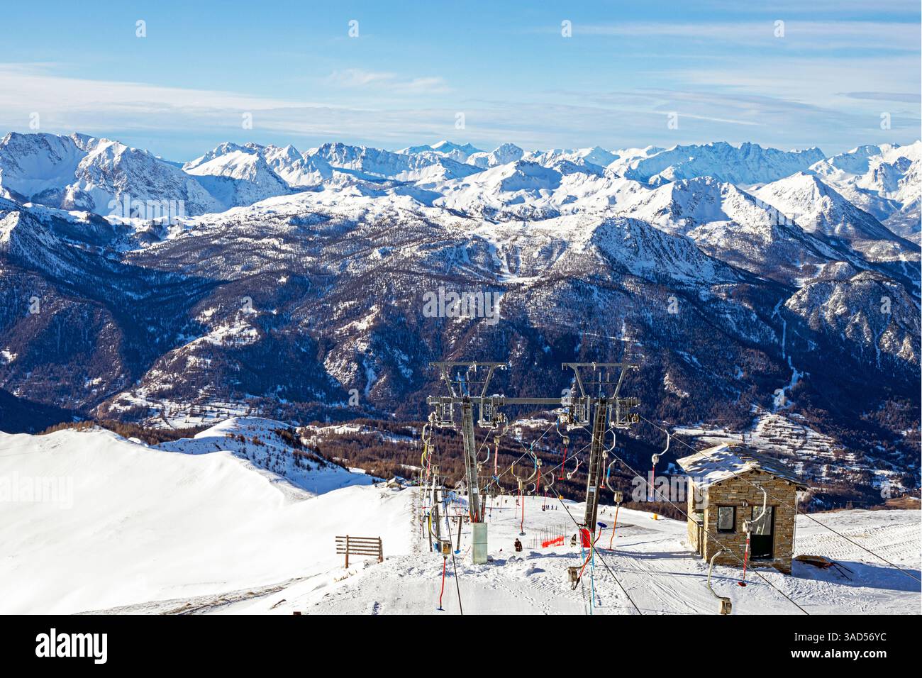 ski lift on top of a mountain in the Alps illuminated by the early sun ...