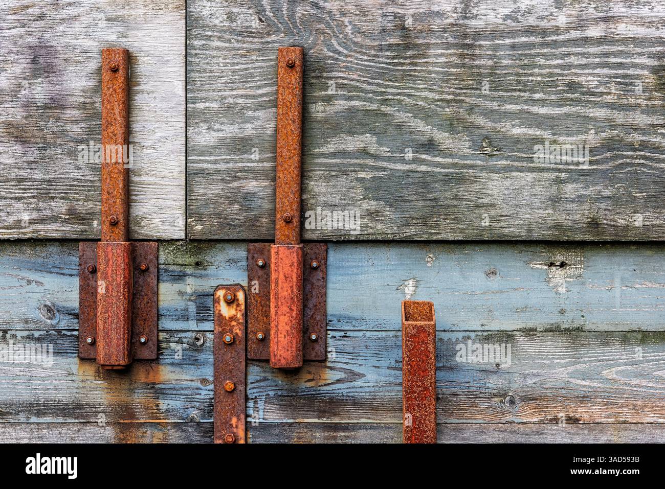 Weathered wood panels exhibit natural textures, with rusty hardware ...