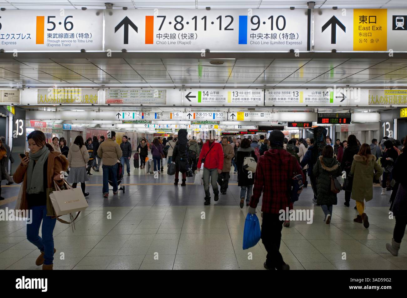 Crowds of commuters making their way through a concourse of the multi ...