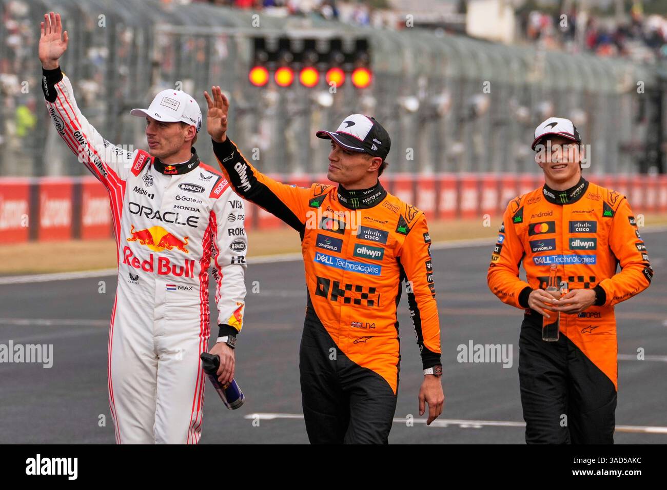 Red Bull driver Max Verstappen of the Netherlands, left, is accompanied ...