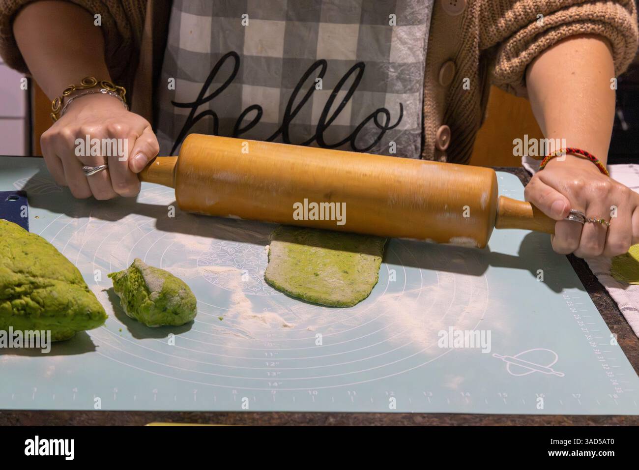 Roll out the green dough (pasta) from the bear garlic evenly using a ...