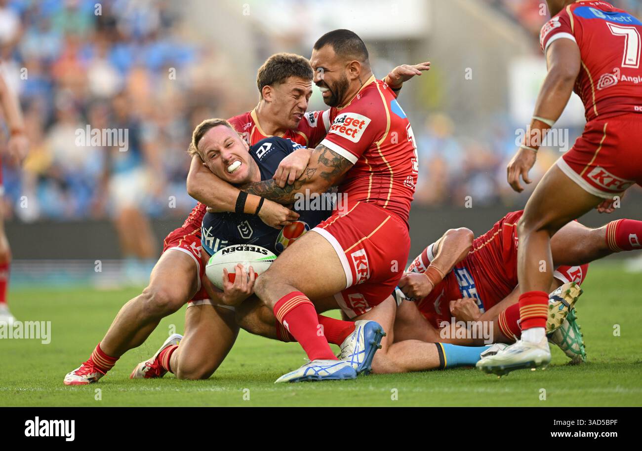 Brock Gray of the Titans is tackled by Josh Kerr of the Dolphins during the NRL Round 5 match ...