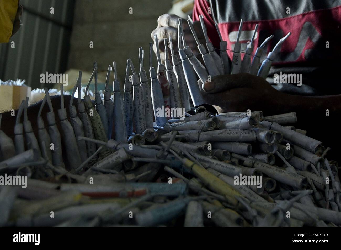 Kimbulapitiya. 4th Apr, 2025. A worker makes firecrackers at a ...