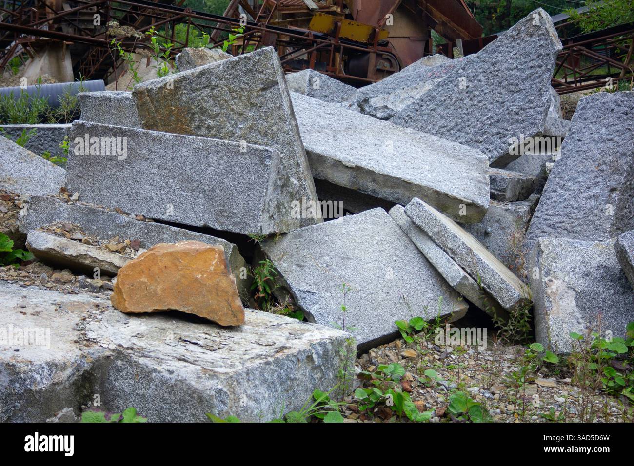 A pile of rubble with a large rock in the middle. The rock is brown and ...