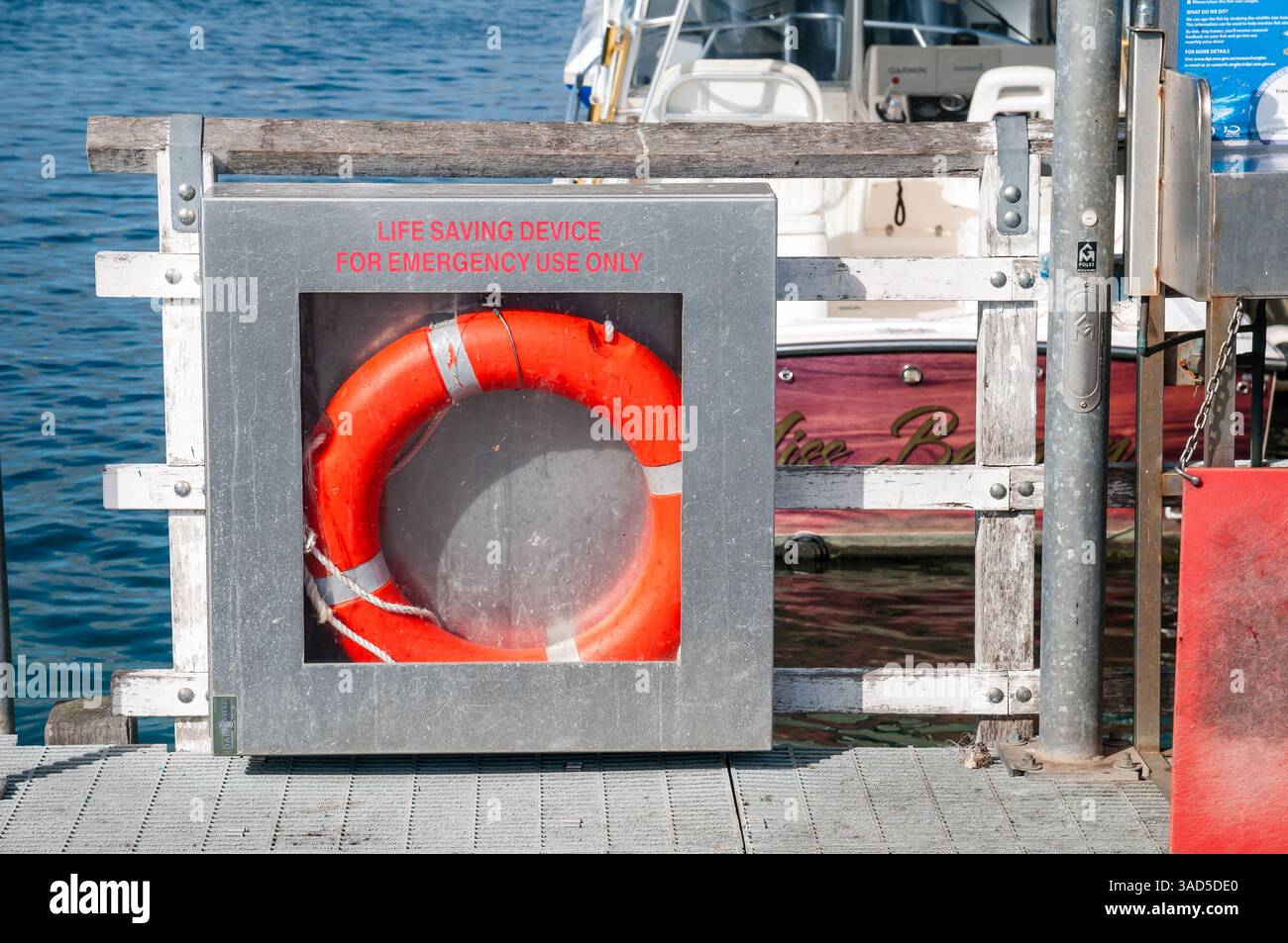 Lifesaving ring buoy in emergency box on marina dock, safety equipment ...