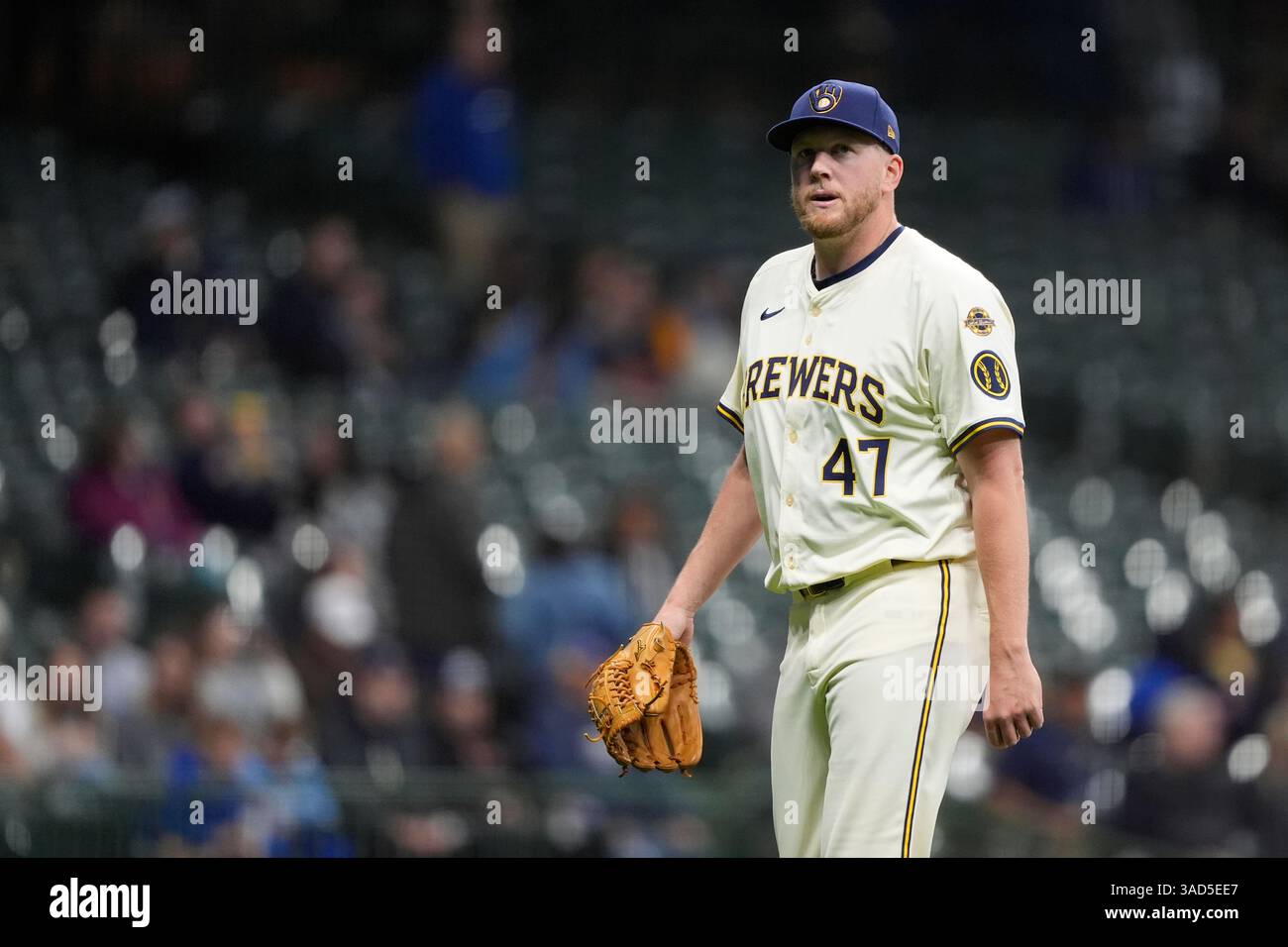Milwaukee Brewers' Jared Koenig looks on as he walks to the dugout ...