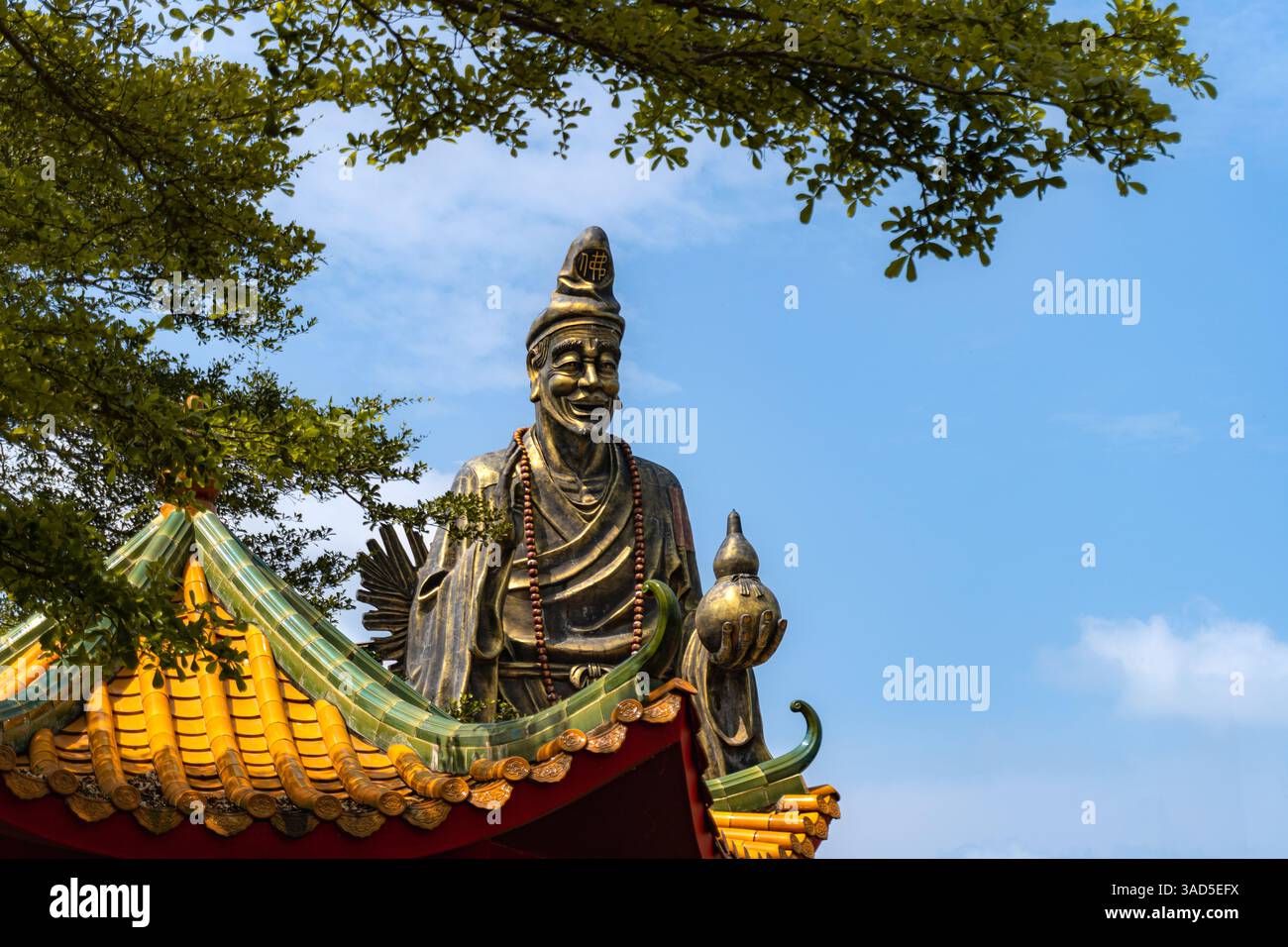 Statue of Ji Gong with Blue Sky and Golden Roof Accent in Yong Peng, Johor, Malaysia Stock Photo ...