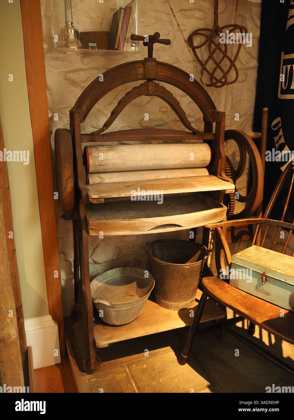 Hand operated cast iron mangle or wringer used to squeeze bulk of water ...