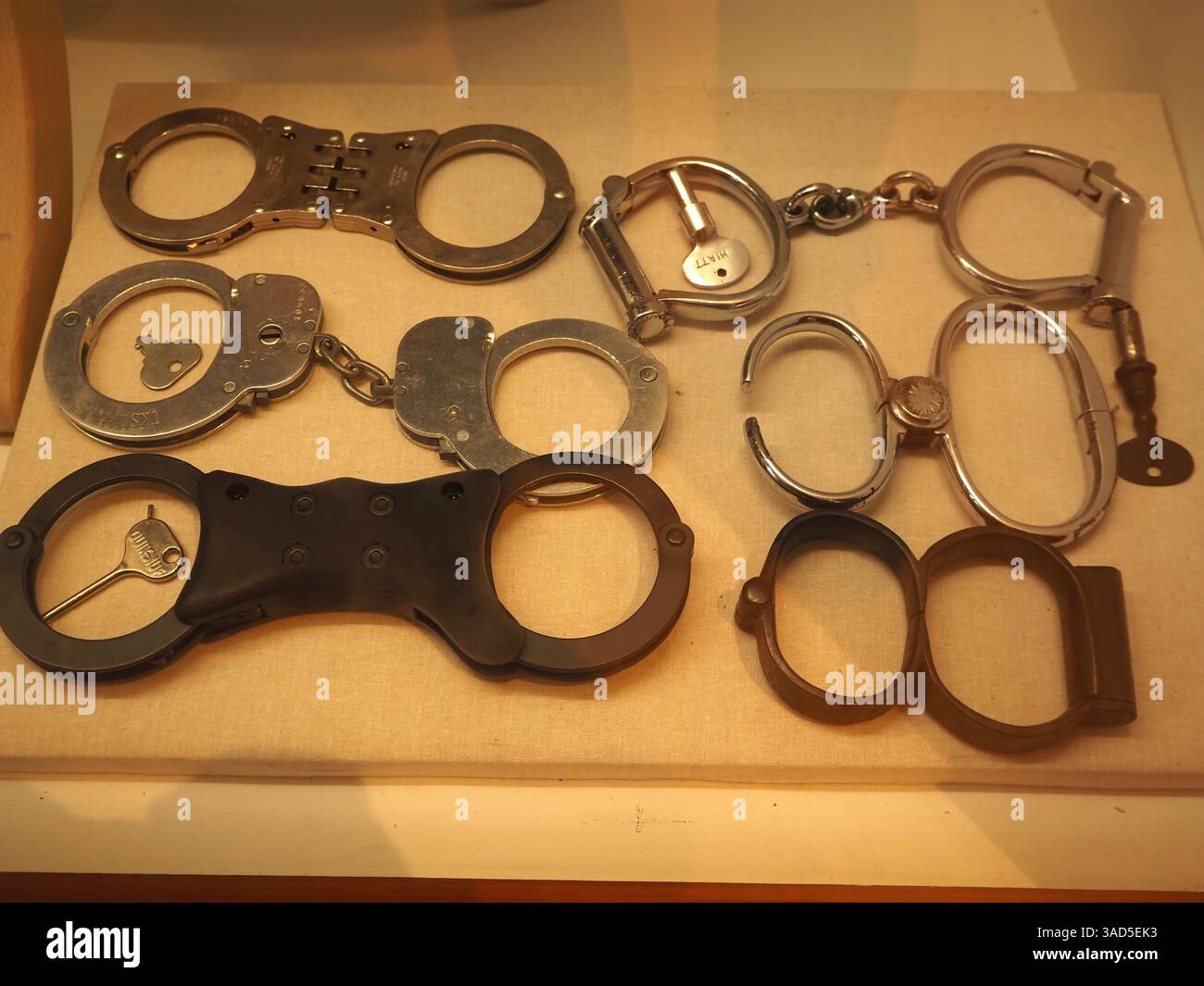 Display of police handcuffs in various designs and styles used over the ...