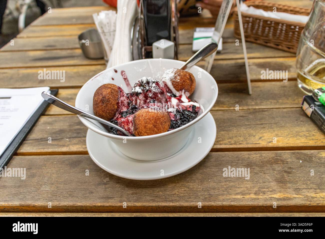 Bucharest. Romania. Papanasi - a traditional Romanian dessert. The cake ...