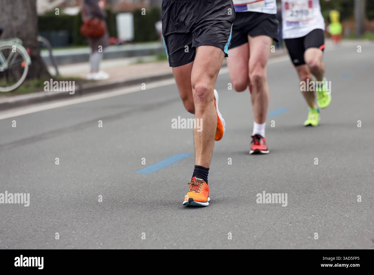 three marathon runners on asphalt Stock Photo - Alamy