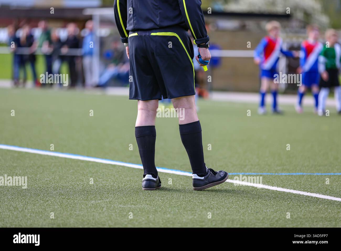 football referee in black clothing with whistle in hand Stock Photo - Alamy