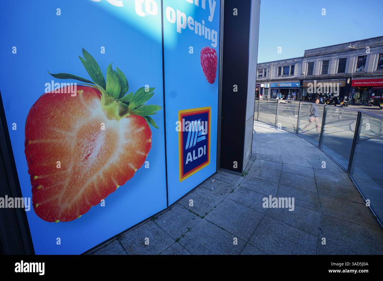 London UK 5 April 2025. Strawberries cover the front of the new Aldi local store ahead of the ...