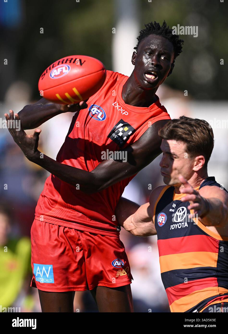 Mac Andrew of the Suns handballs during the AFL Round 4 match between the Gold Coast Suns and ...