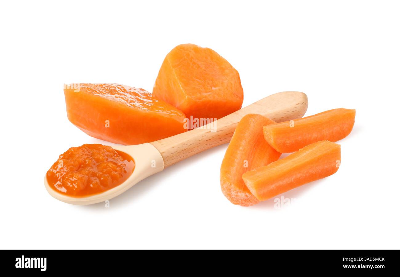 Baby food. Tasty puree in spoon, carrot and persimmon isolated on white ...