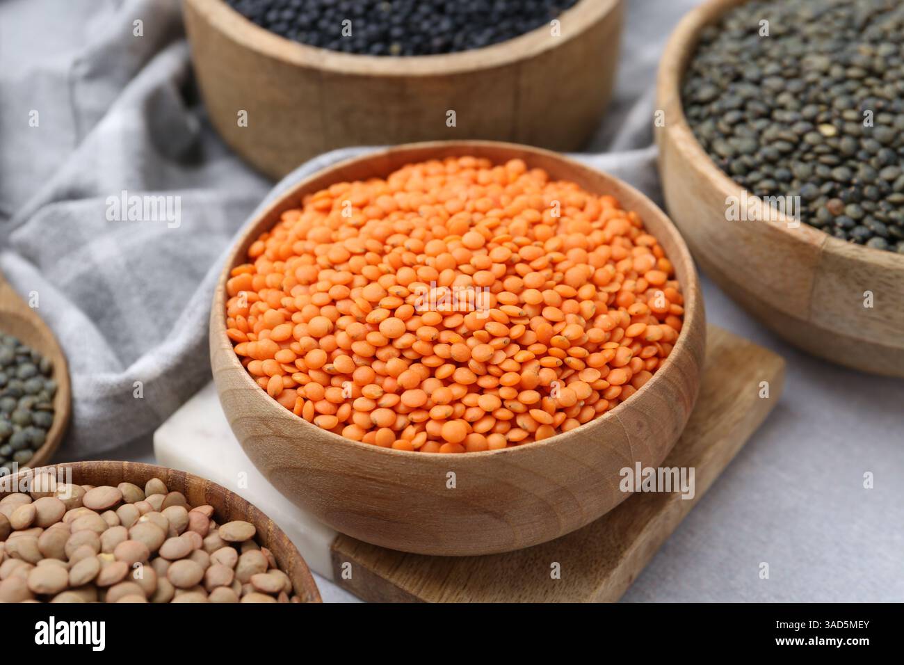 Different types of lentils on light table, closeup Stock Photo - Alamy