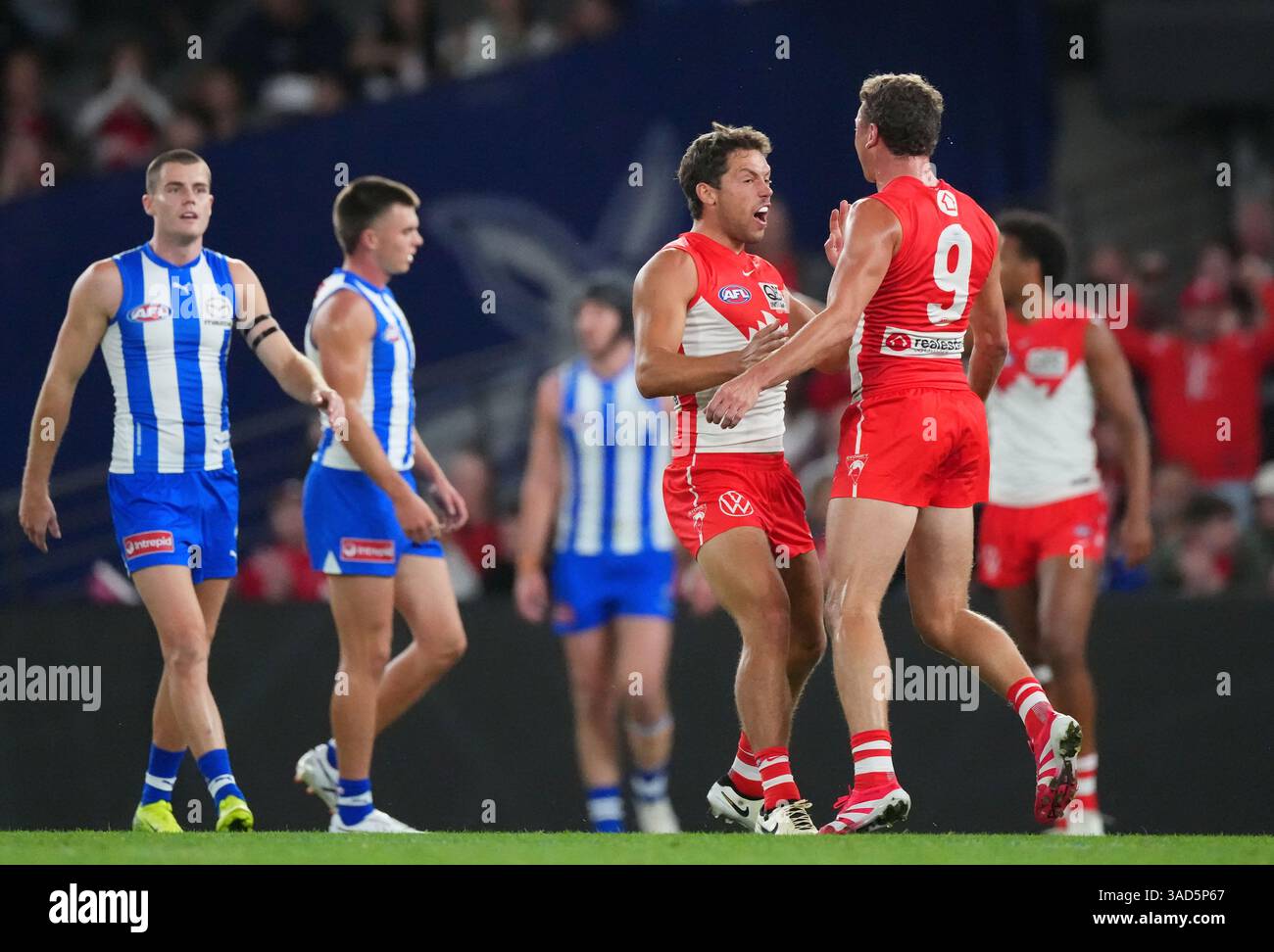 Oliver Florent of the Swans celebrates after kicking a goal with Will ...
