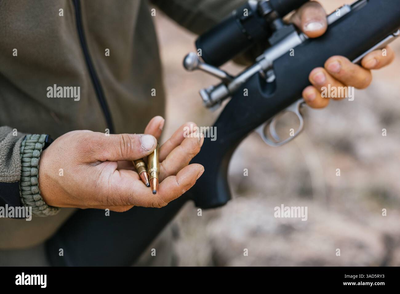 Hunter holding rifle and bullets getting ready for the hunt Stock Photo ...