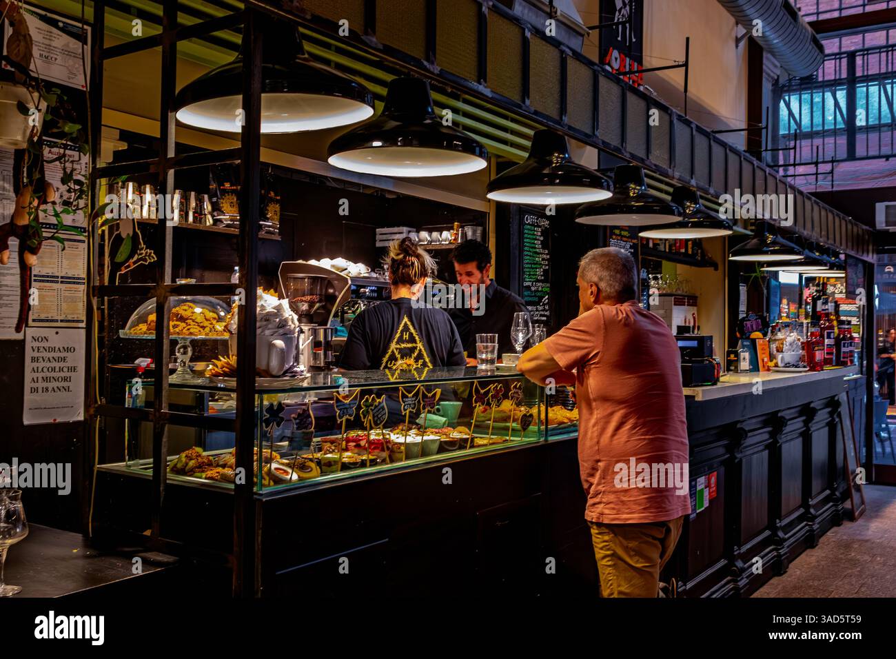 A man being served at a coffee shop inside Mercato di Mezzo, a lively covered food market in the ...
