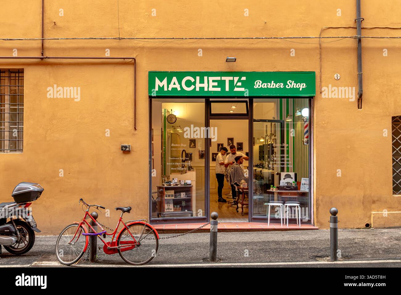 A man getting a haircut inside Machete ,a barber shop on Via San Vitale ...