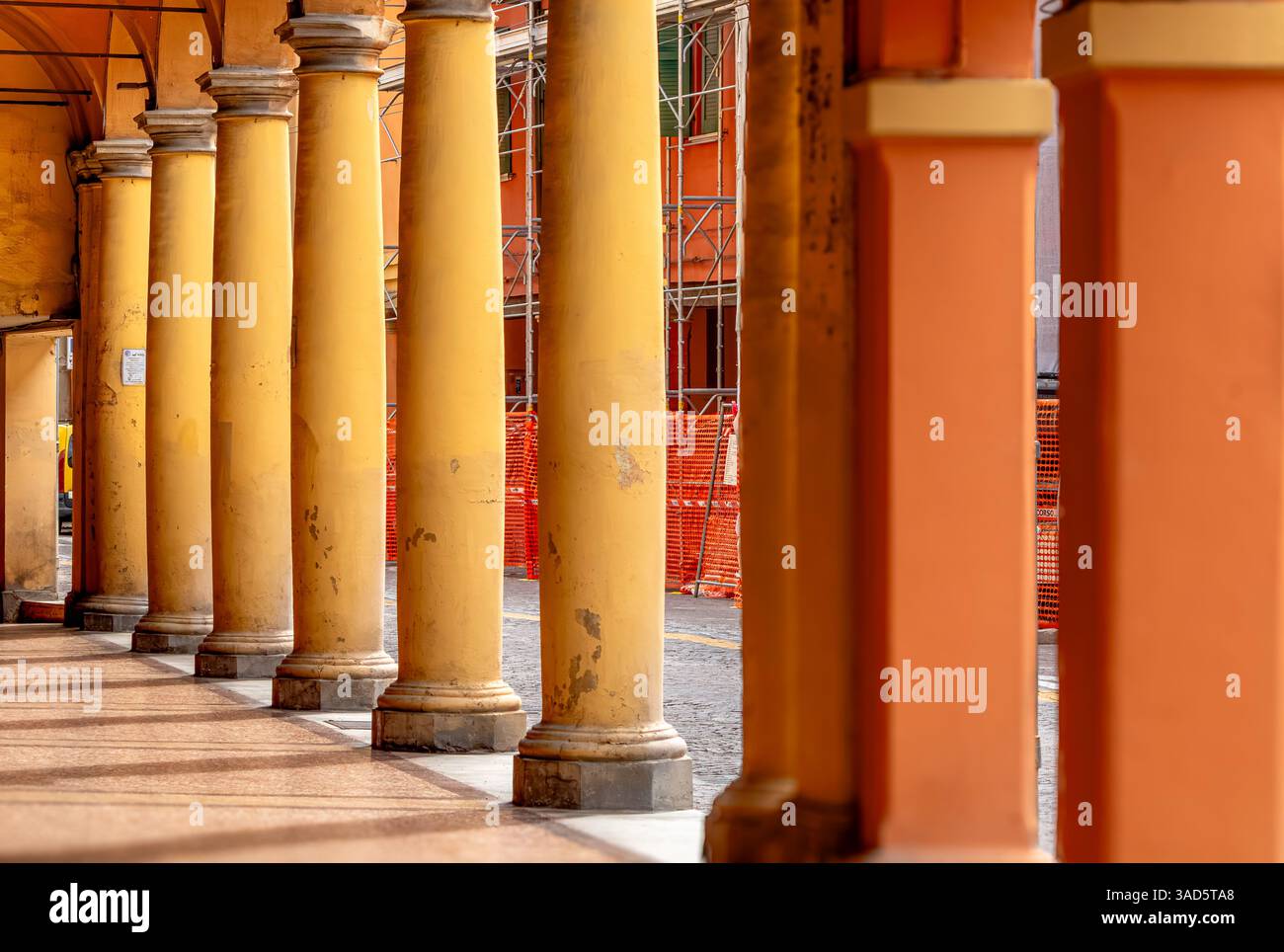 Pastel coloured columns of a portico along Via Santo Stefano ,Bologna ...