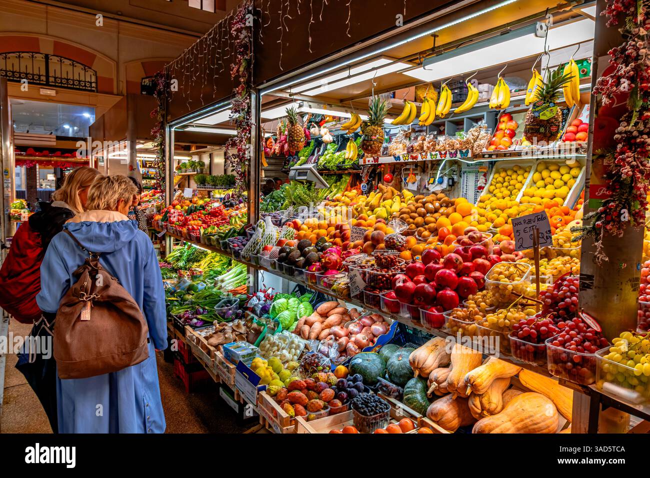People shopping for fruit and vegetables at a stall inside Mercato ...