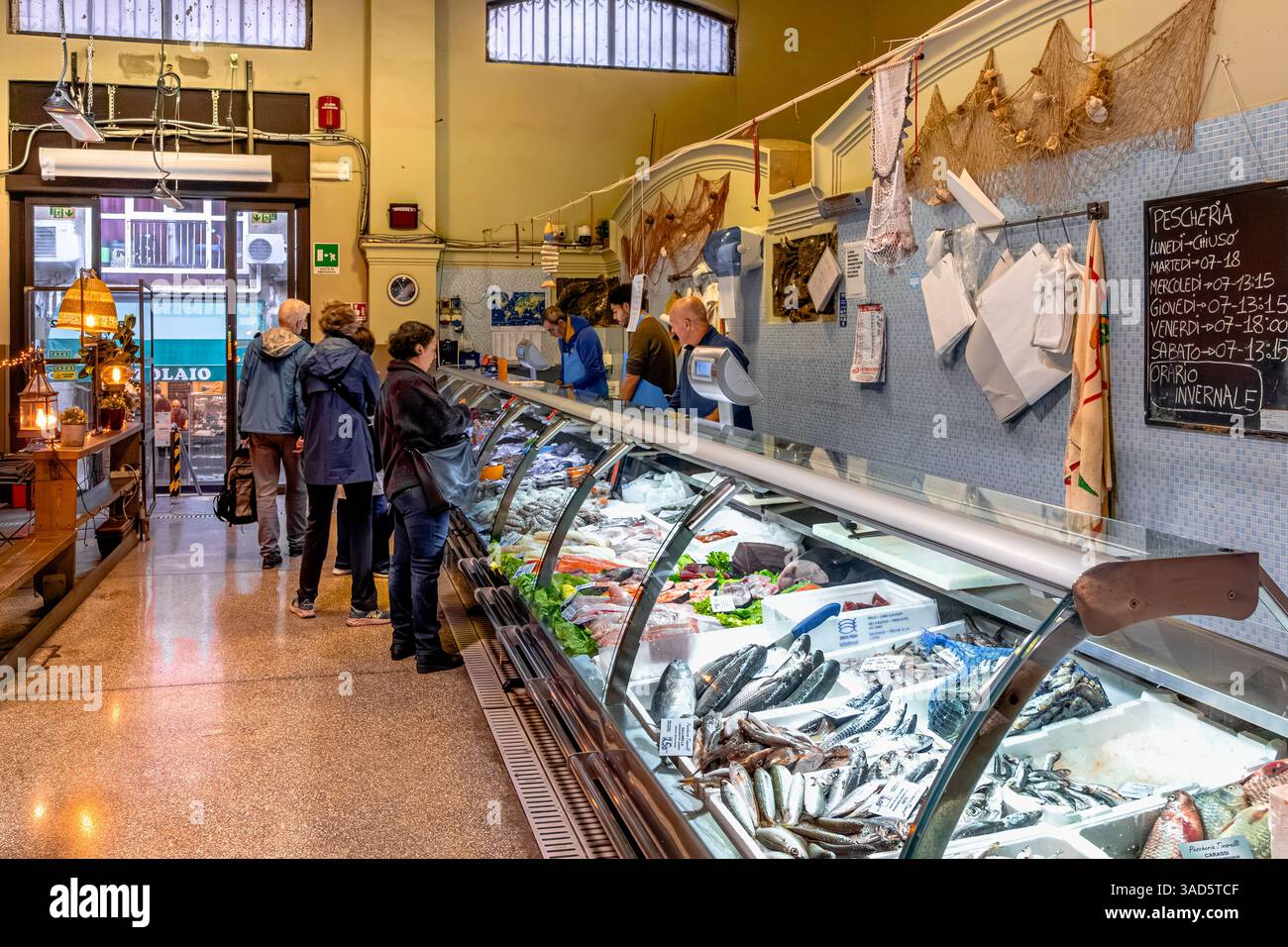 People shopping for fresh fish at a fish monger inside Mercato delle ...