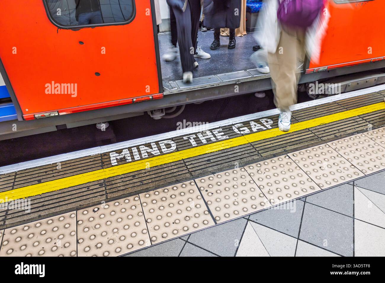Mind the Gap safety warning at London Tube platform with train doors ...
