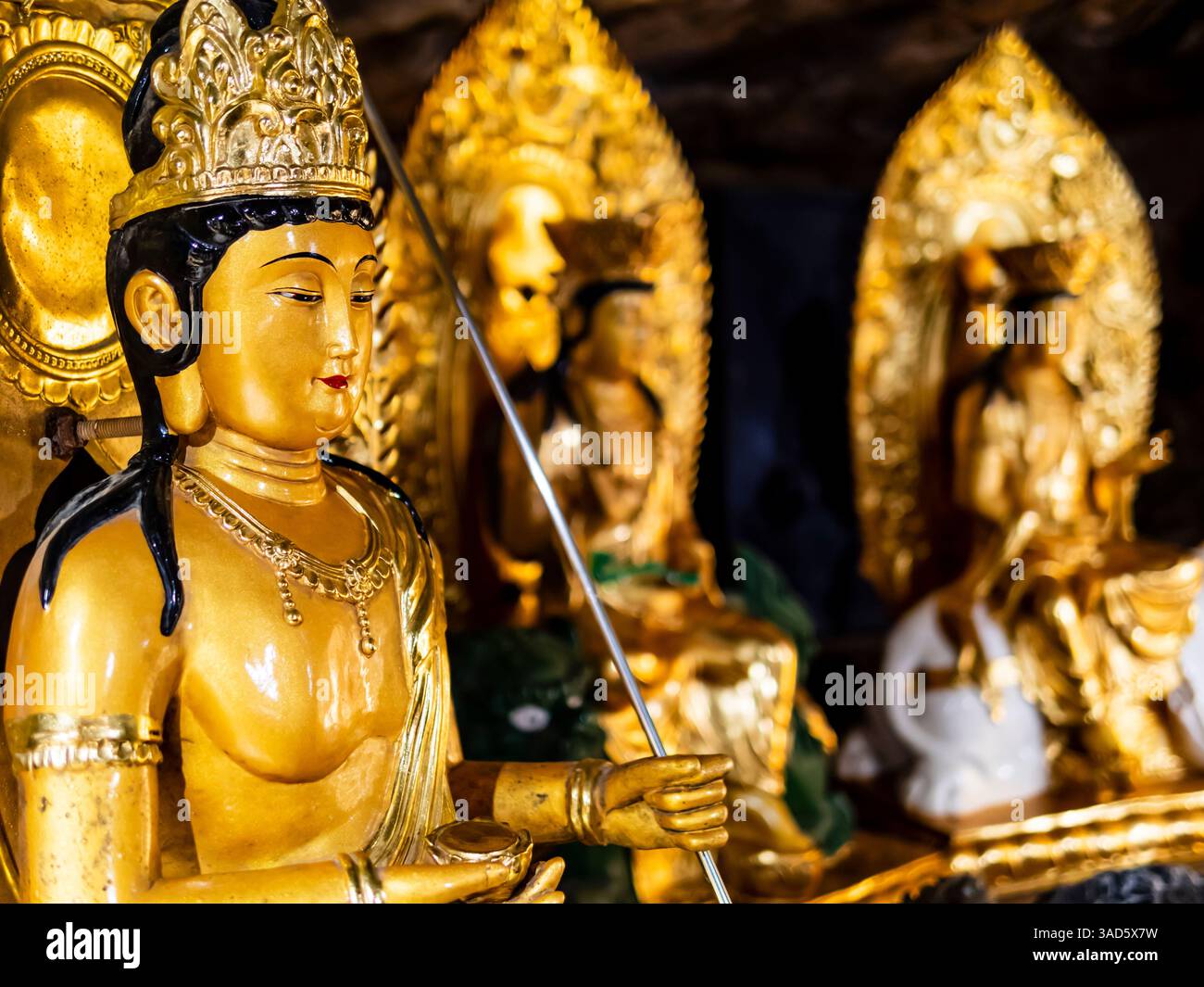 Stunning golden Buddha statues in Fubo Hill cave, Guilin, China Stock ...