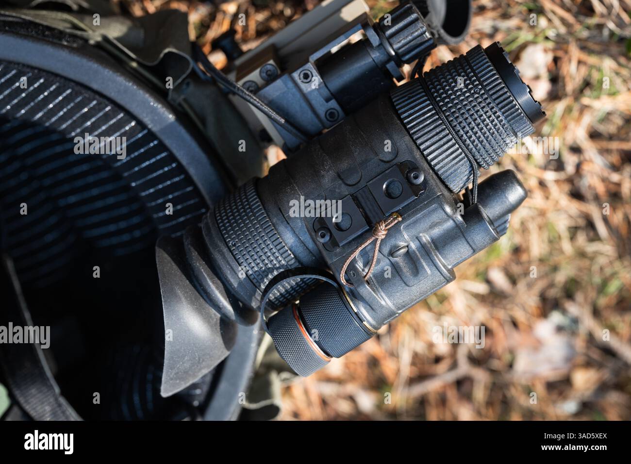 Modern tactical Gen 3 night vision monocular, mounted on a combat ...