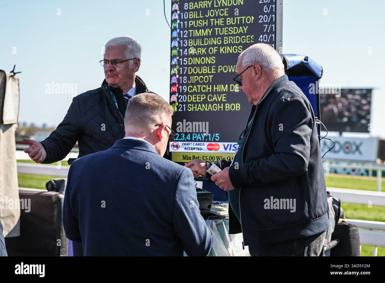 Racegoers place bets on the races during the Randox Grand National 2025 ...