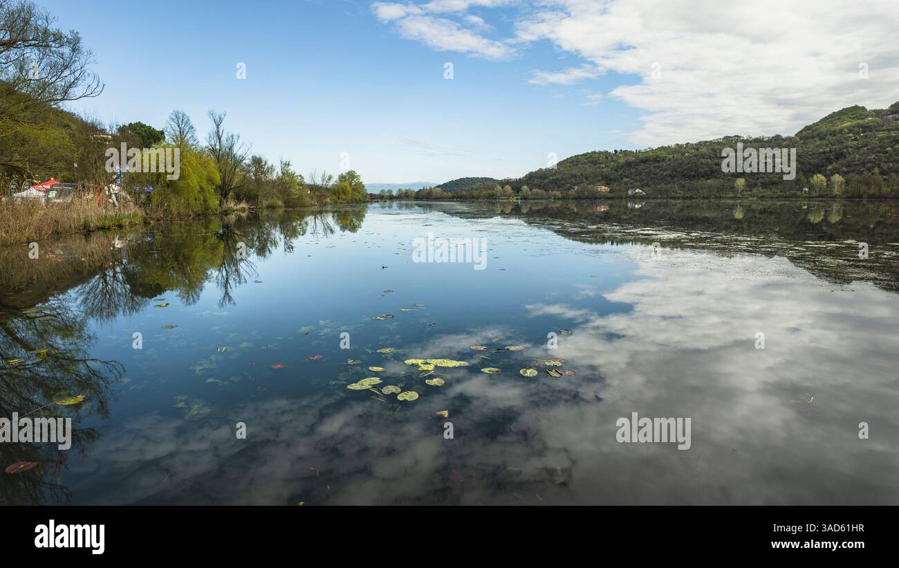 Serene landscape featuring the calm waters of lake fimon reflecting the ...