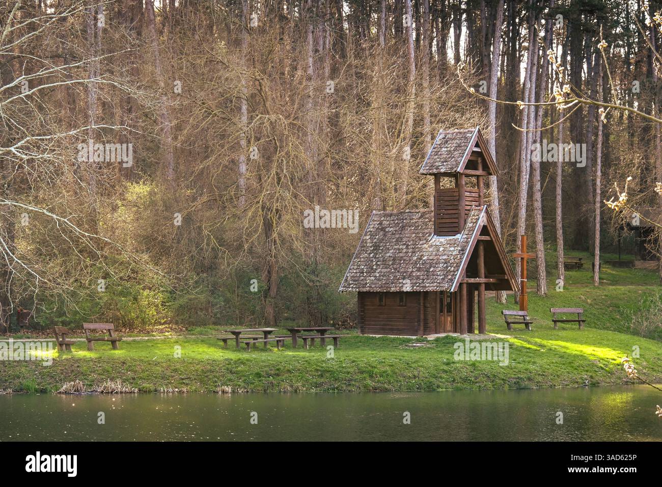 A little wooden chapel by the lake, nestled in the tranquility of the ...